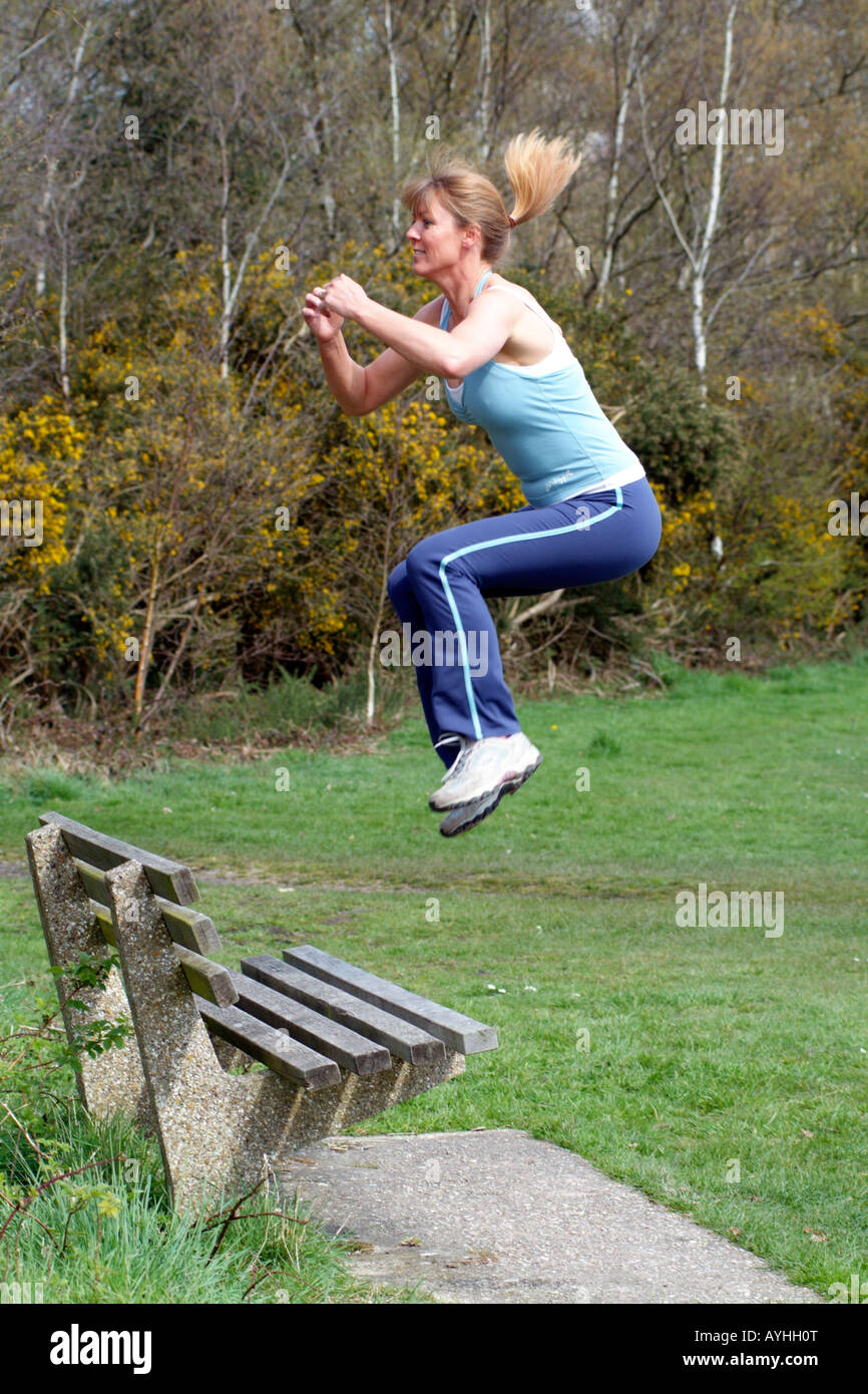 Keep Fit Exercise Woman Jumping off a Park Bench Stock Photo - Alamy