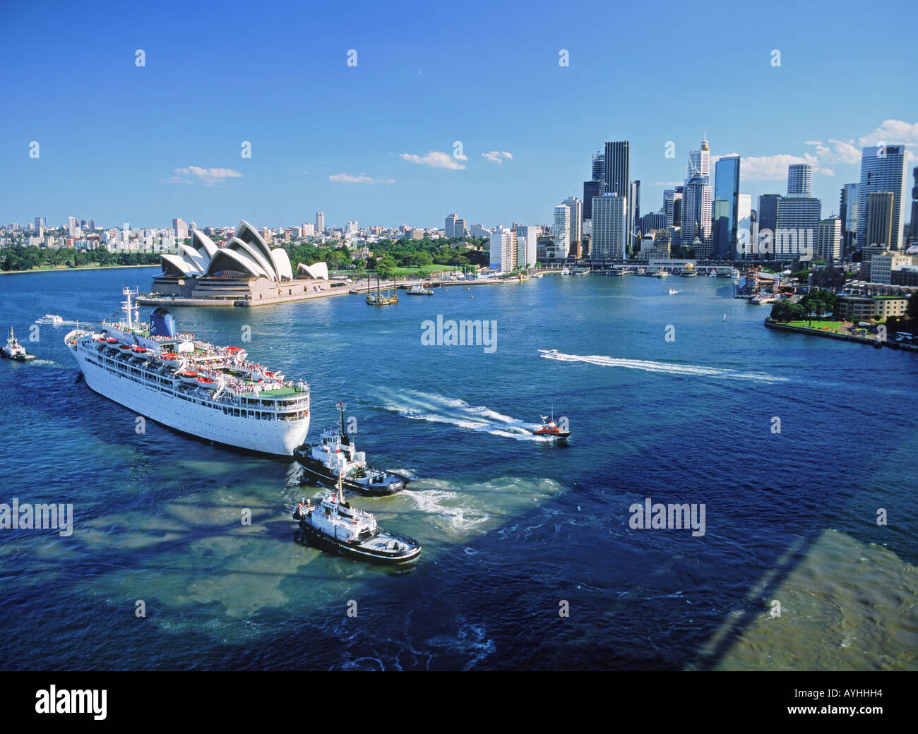 Tug boats guiding passenger cruise ship into Sydney Harbour at Circular ...