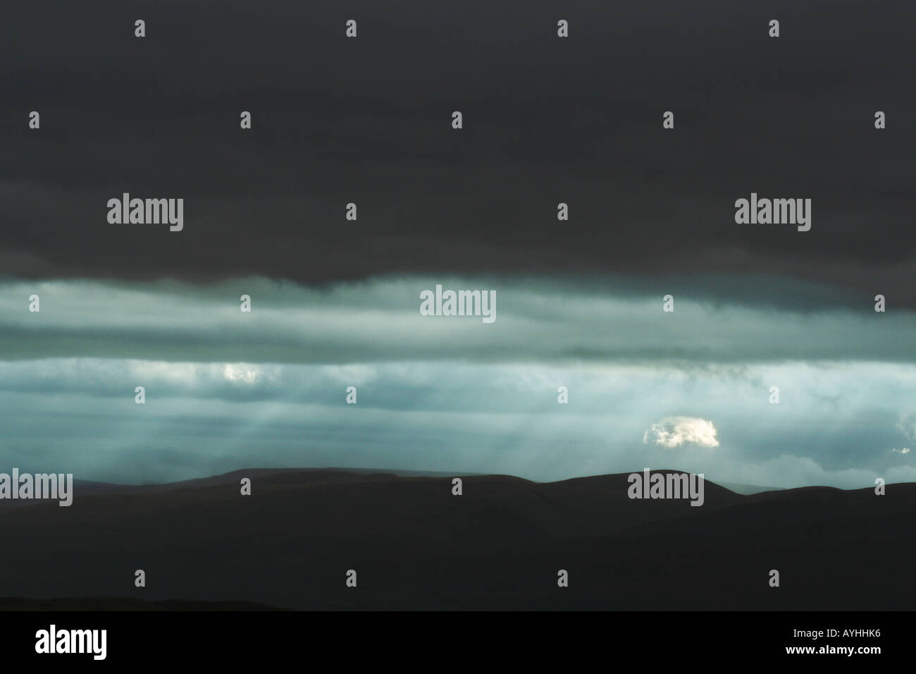 a single white cloud floating over the horizon Stock Photo - Alamy