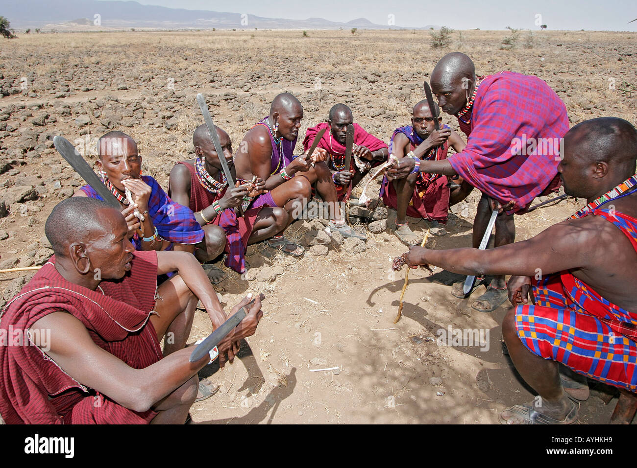 Maasai elders eat goat ribs Stock Photo - Alamy