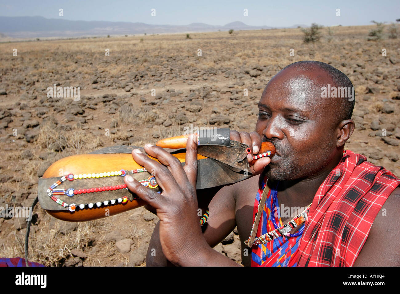 Maasai elder drinks fresh milk from a gourd Stock Photo - Alamy