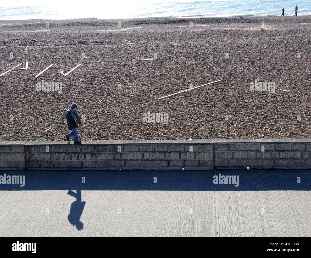boy walking along wall on Brighton promenade Stock Photo - Alamy