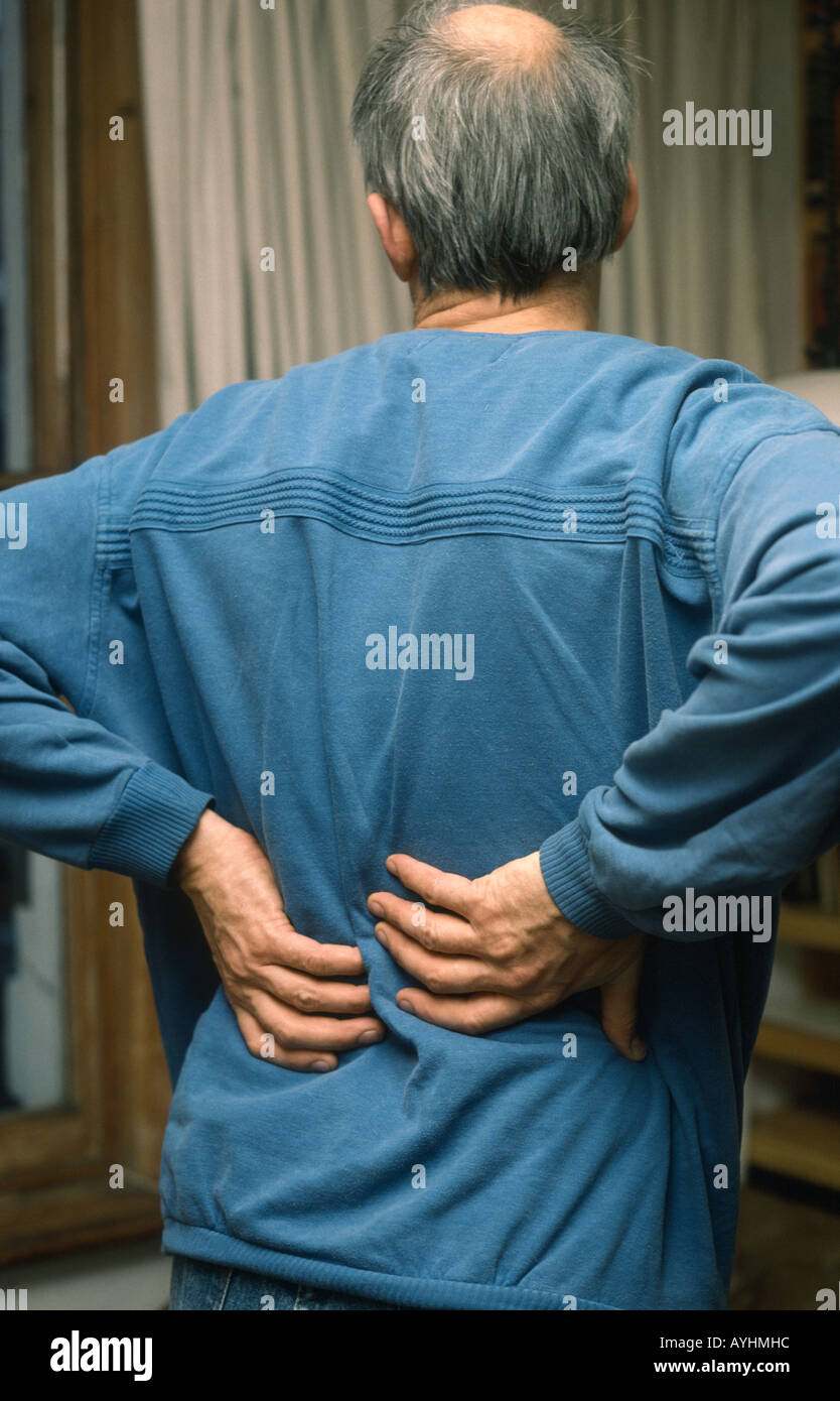 Elderly man suffering from lower back pain Stock Photo - Alamy