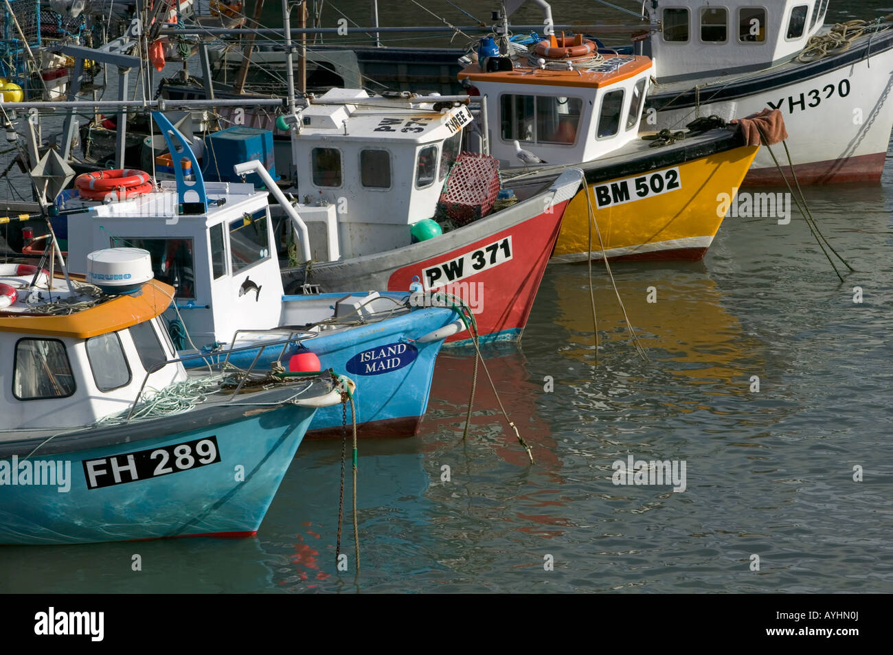 A row of fishing boats in a harbour Stock Photo - Alamy