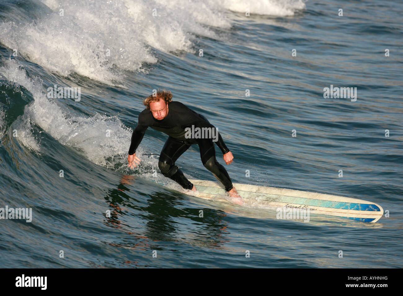 A Surfer riding a longboard Stock Photo - Alamy
