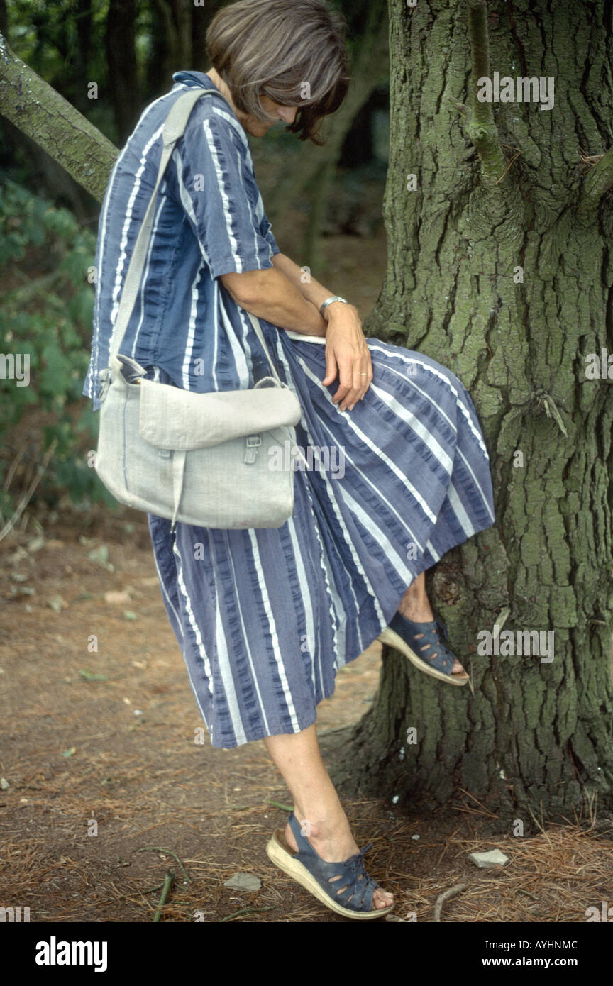 woman sitting on branch of a tree Stock Photo - Alamy