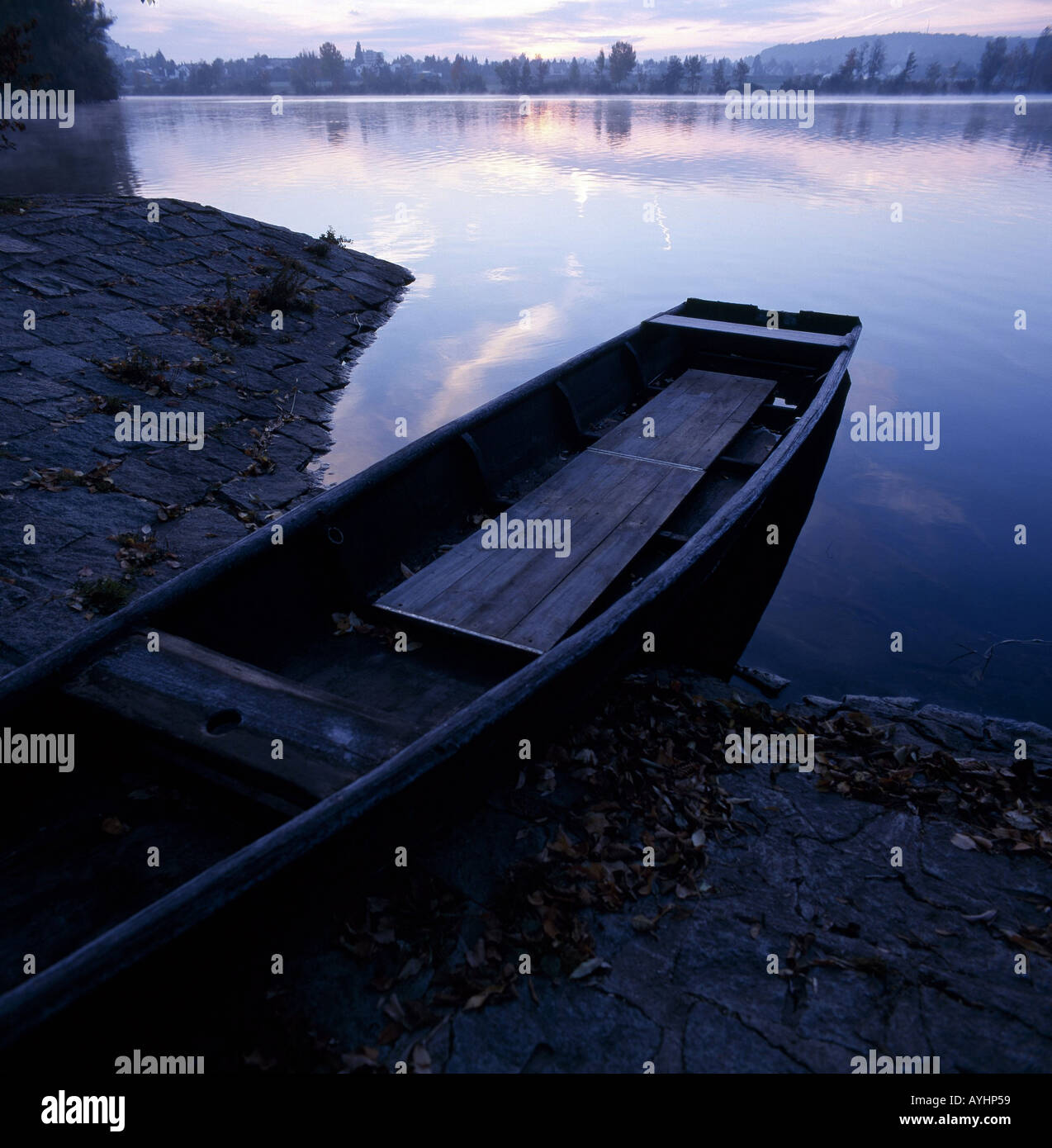 Rowing boat at sunrise at river donau danube hi-res stock photography ...