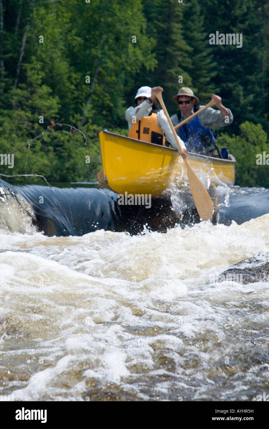 Couple shooting rapids in canoe Stock Photo - Alamy