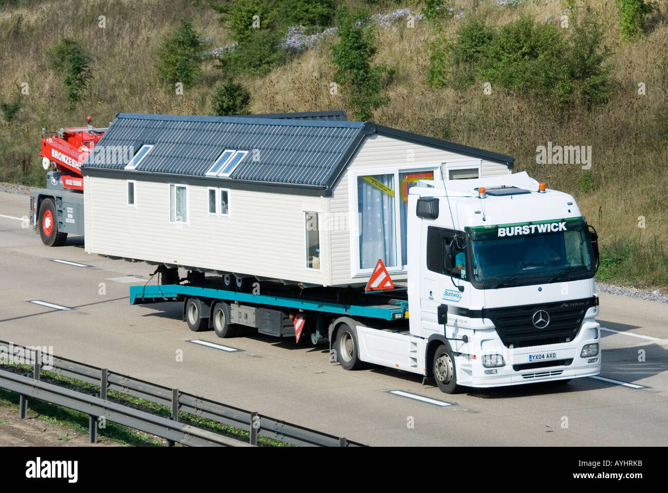 White Mercedes lorry truck with wide oversized load prefabricated ...