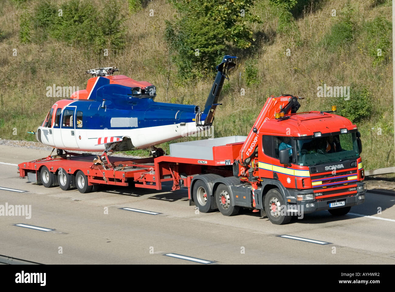 M25 motorway helicopter fuselage on low loader trailer behind Scania ...