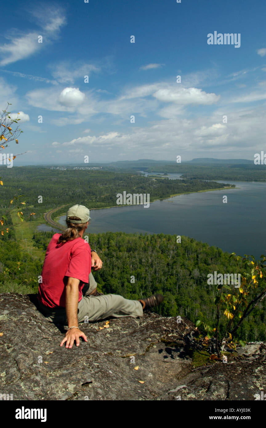 man sitting on scenic lookout Stock Photo - Alamy
