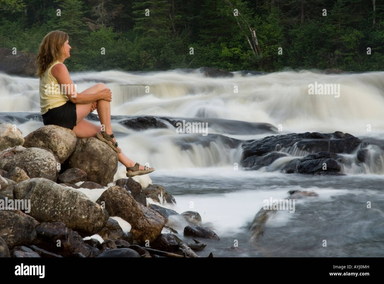 woman sitting beside falls Stock Photo - Alamy