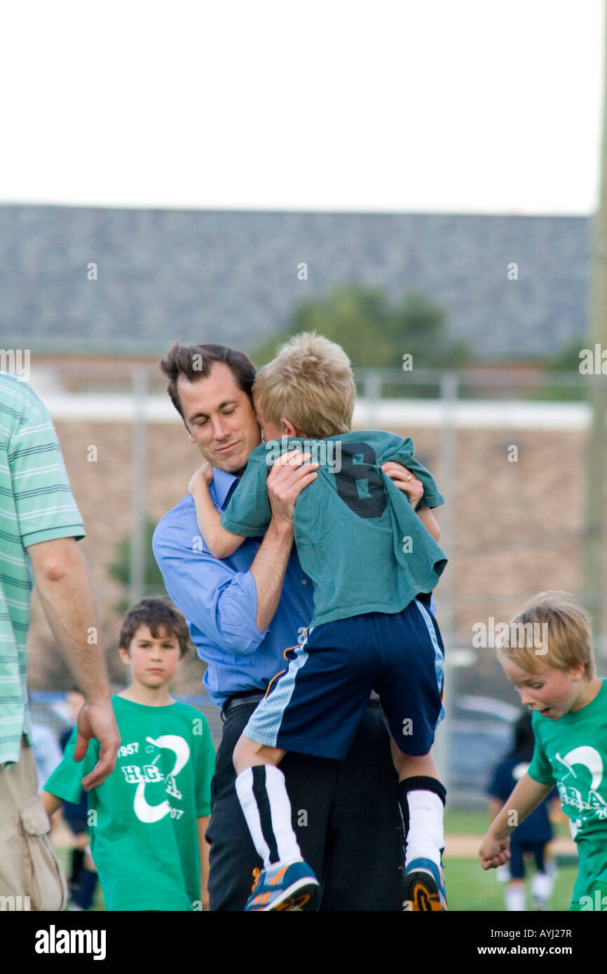 Dad carrying young boy off field after being injured in soccer game ...