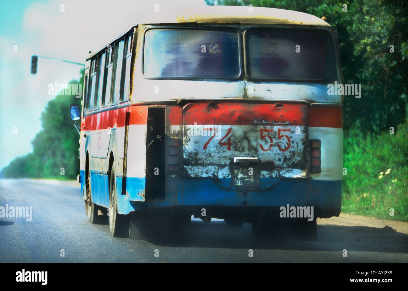old beat up bus travelling along road around the outskirts of Moscow ...
