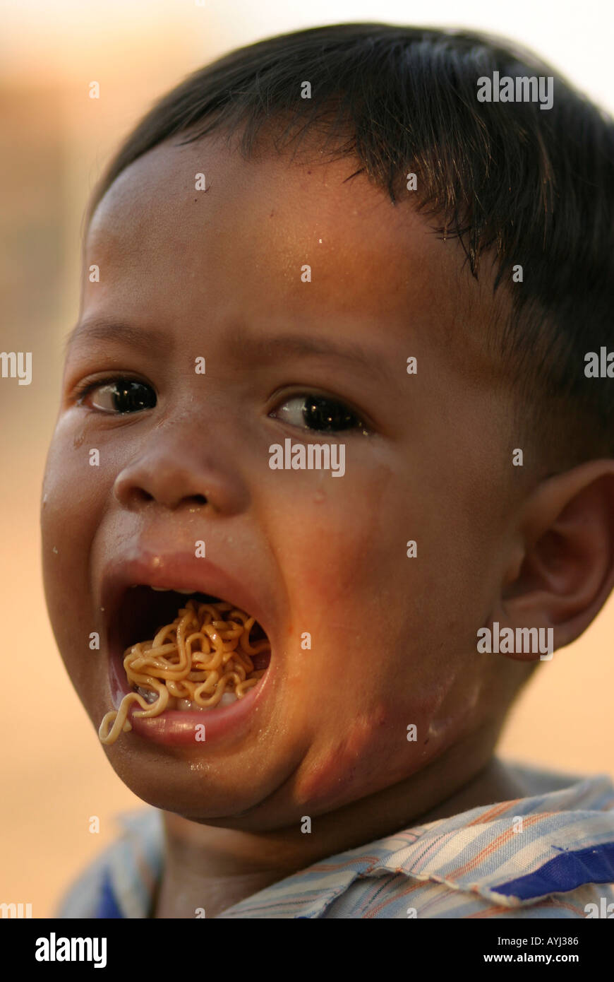 young boy mouth open crying with noodles Stock Photo - Alamy