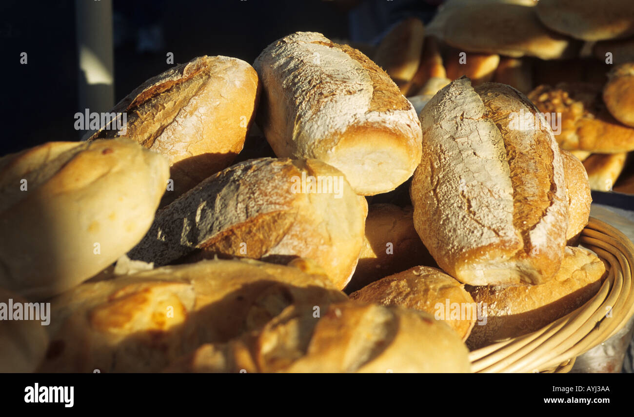 Sun drenched loaves of fresh artisan breads in large baskets Stock ...