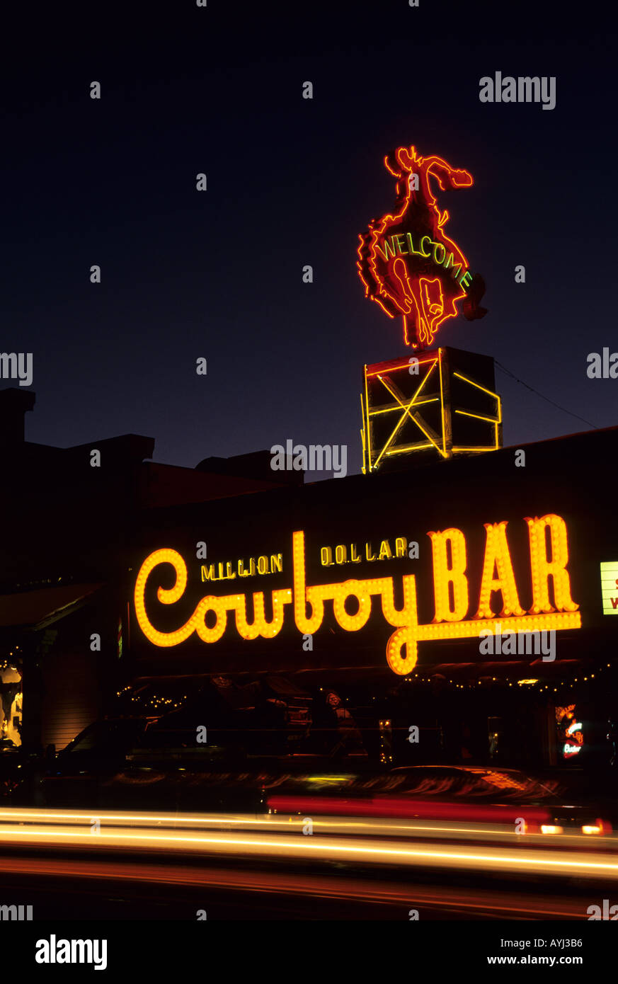 Jackson Hole The Cowboy Bar at night with streaming and neon lights ...
