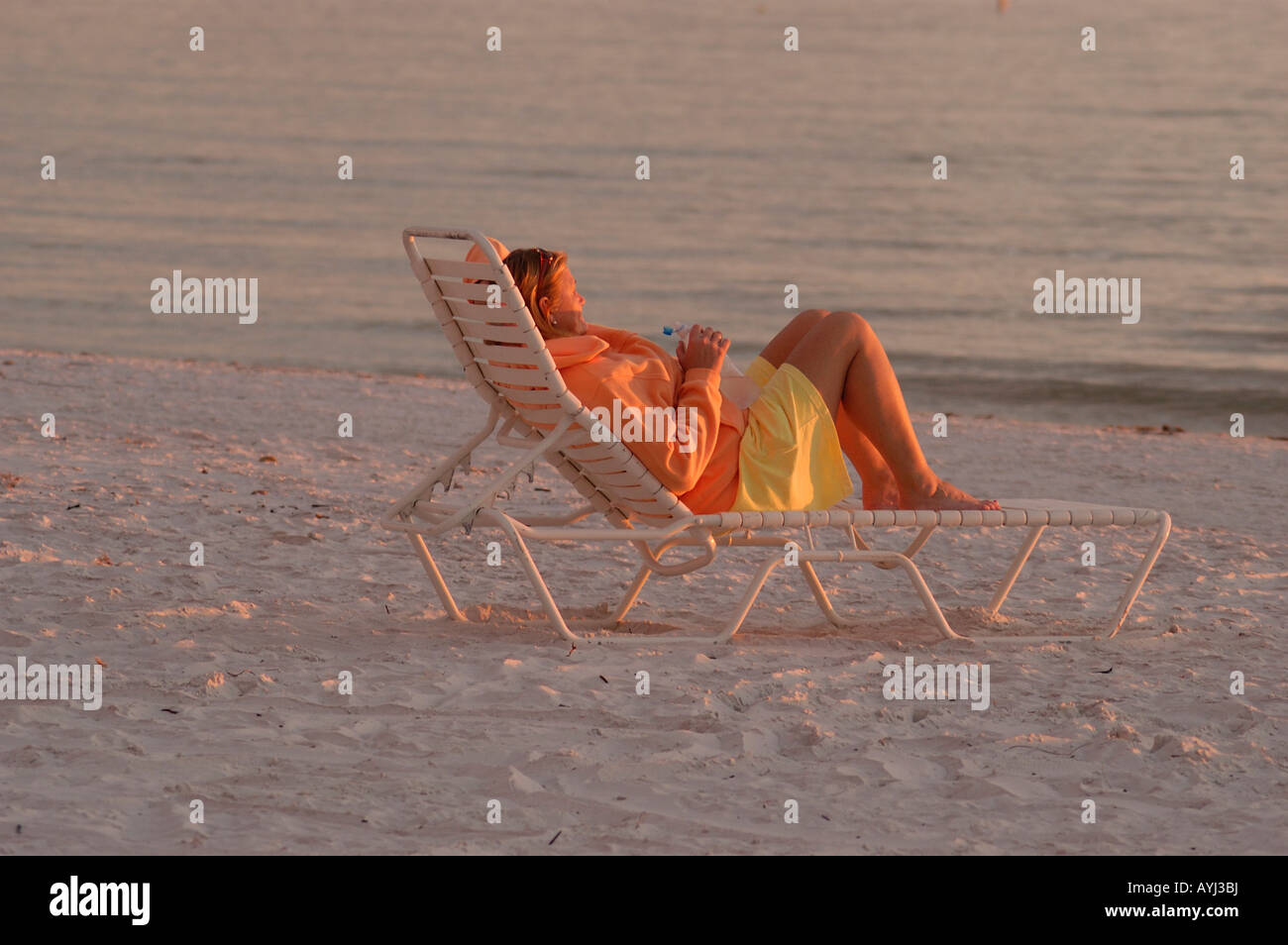Woman beach sunset relaxing hi-res stock photography and images - Alamy