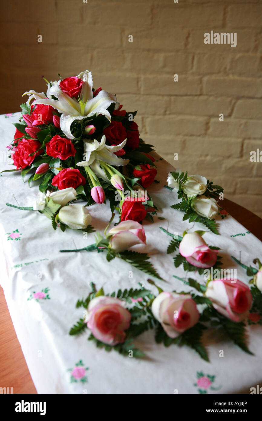 Bridal bouquet of colourful flowers on flower box with matching button ...