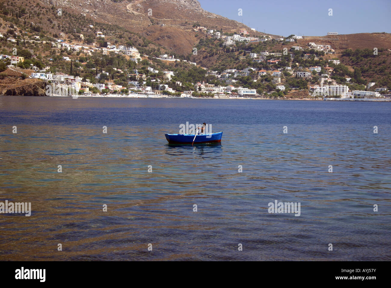 Greek Boy rowing blue boat off Kalymnos, Greece Stock Photo - Alamy