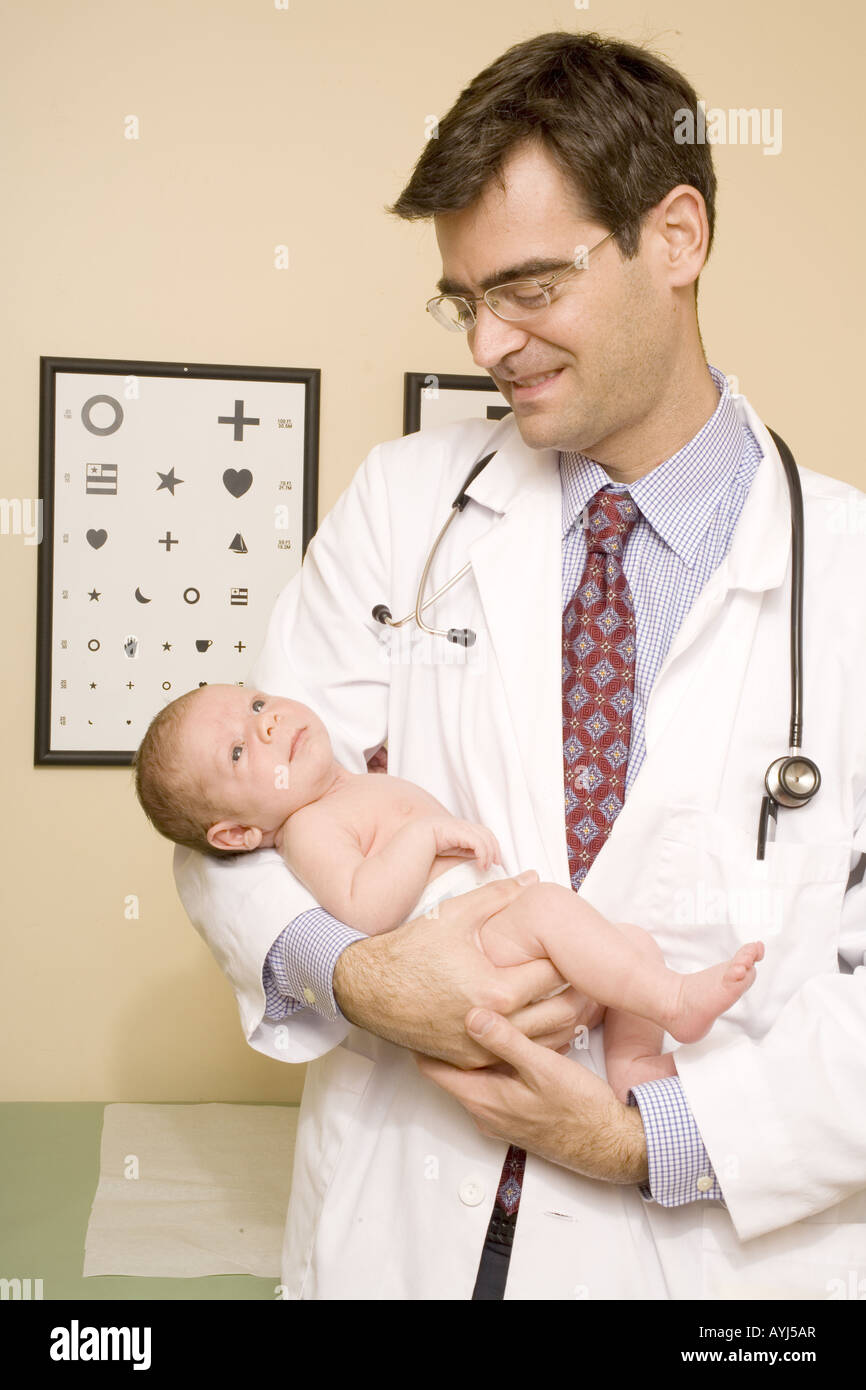 A pediatrician doctor performs a newborn medical examination Stock ...