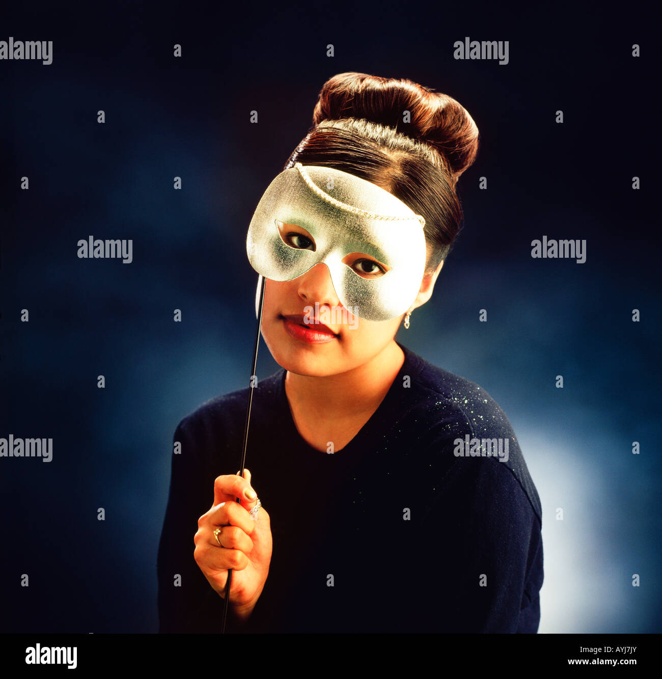 Woman holding mask over eyes Stock Photo - Alamy