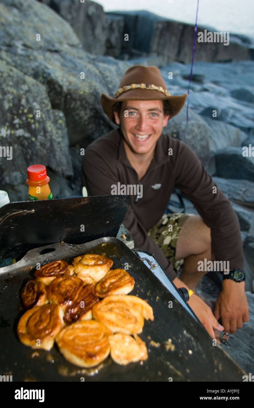 Paddling guide with cinnamon buns at campsite Stock Photo - Alamy