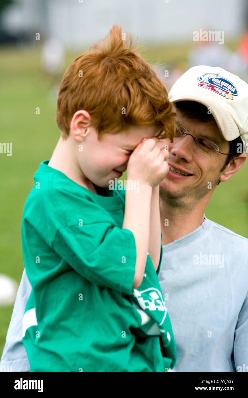 Injured soccer player boy age 7 crying being carried off field by dad ...