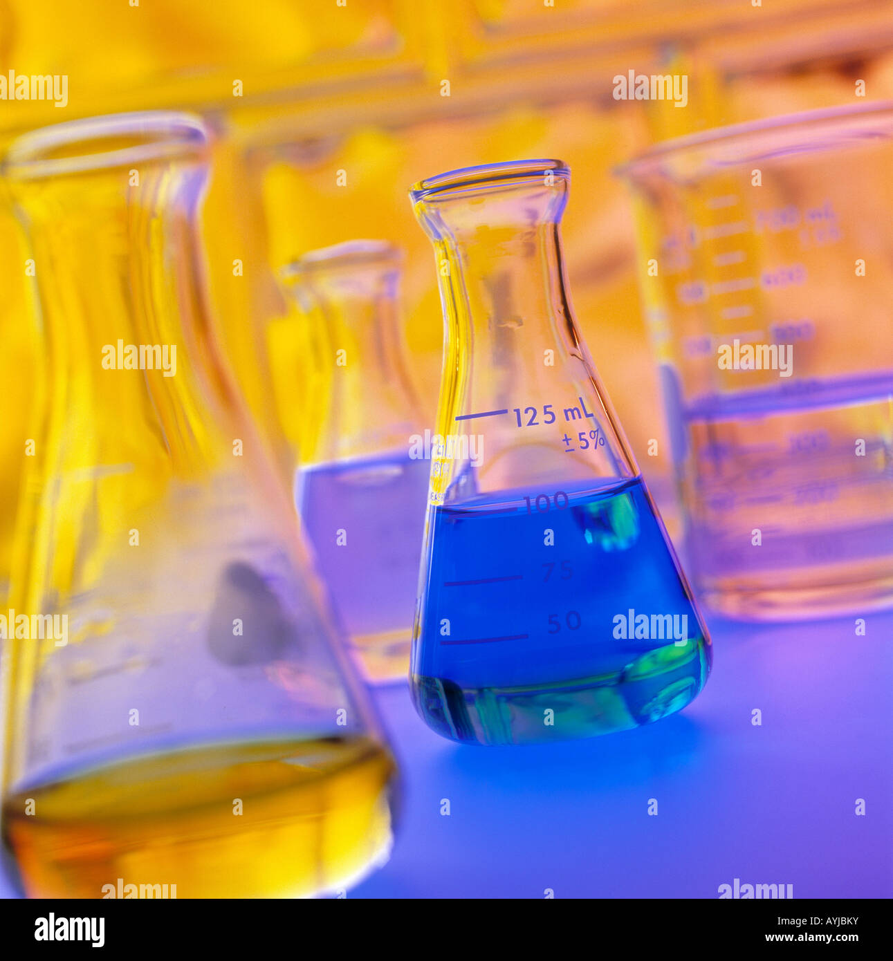 lab flasks with color glass block wall depicting laboratory testing for ...