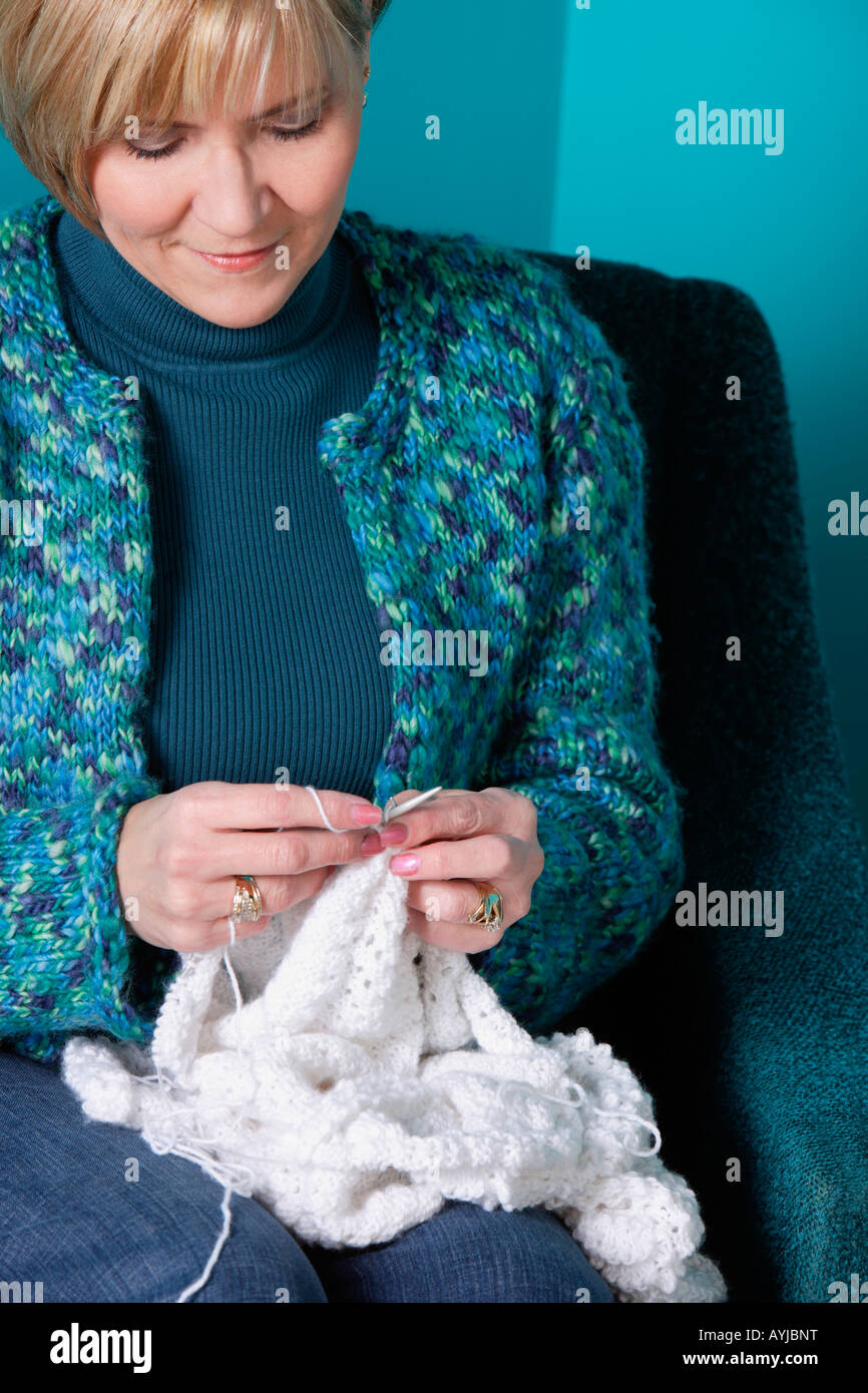 Woman doing needle work Stock Photo - Alamy