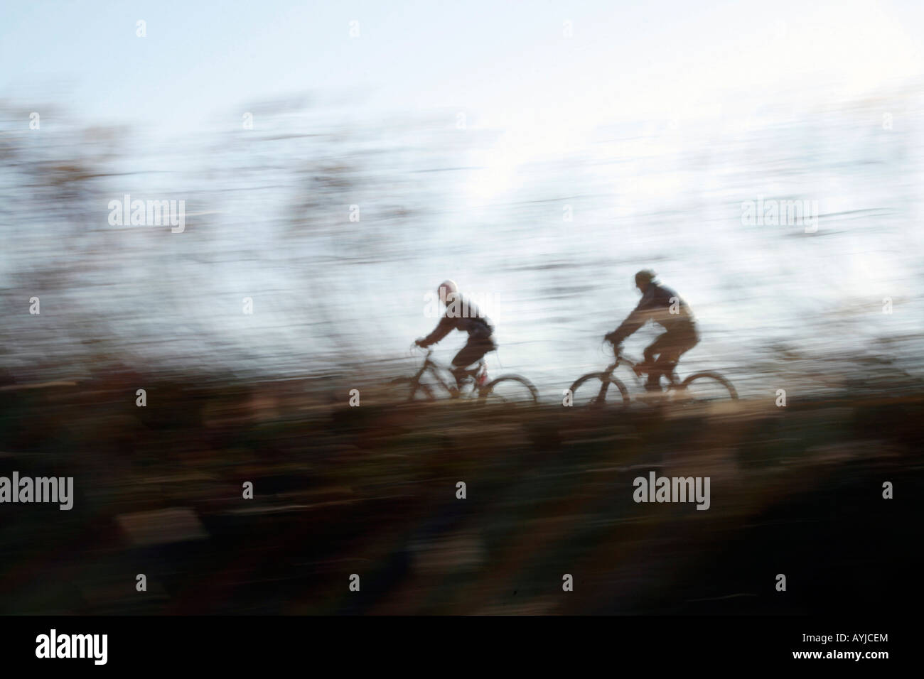 two people riding fast bike in countryside Stock Photo - Alamy