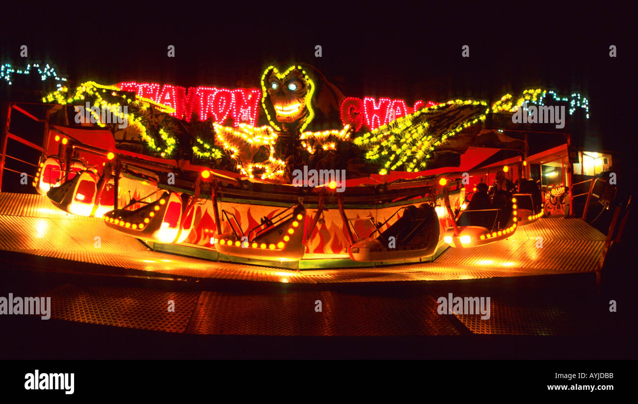 Fair ground rides night time exposures swirling movement UK England ...