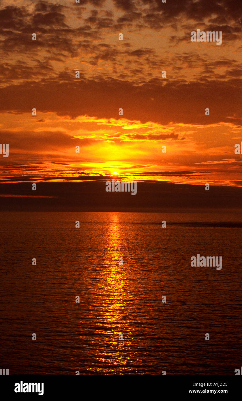 sunset over water Stock Photo - Alamy