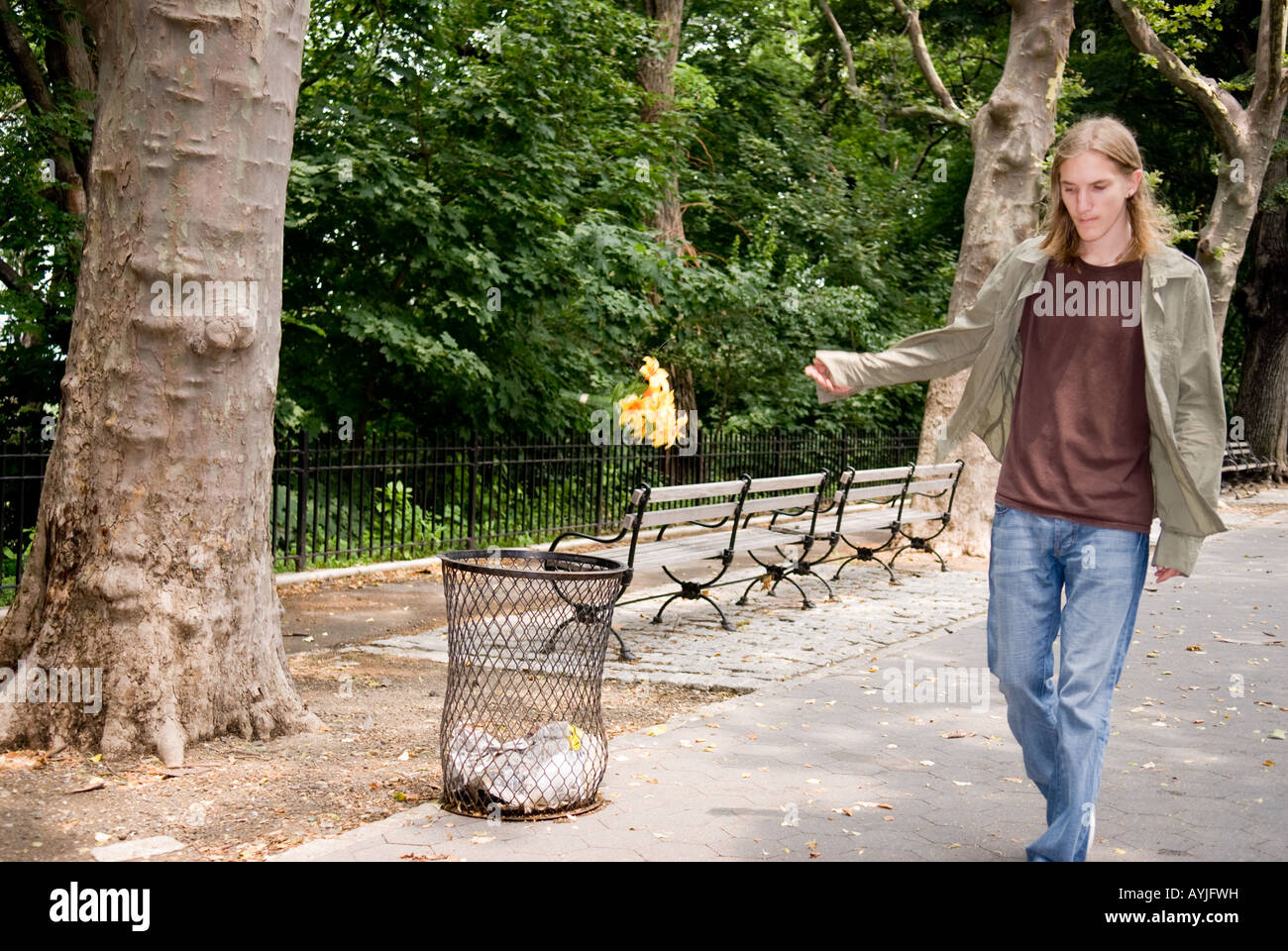 young Caucasian boy disheartened throwing away flowers Stock Photo - Alamy