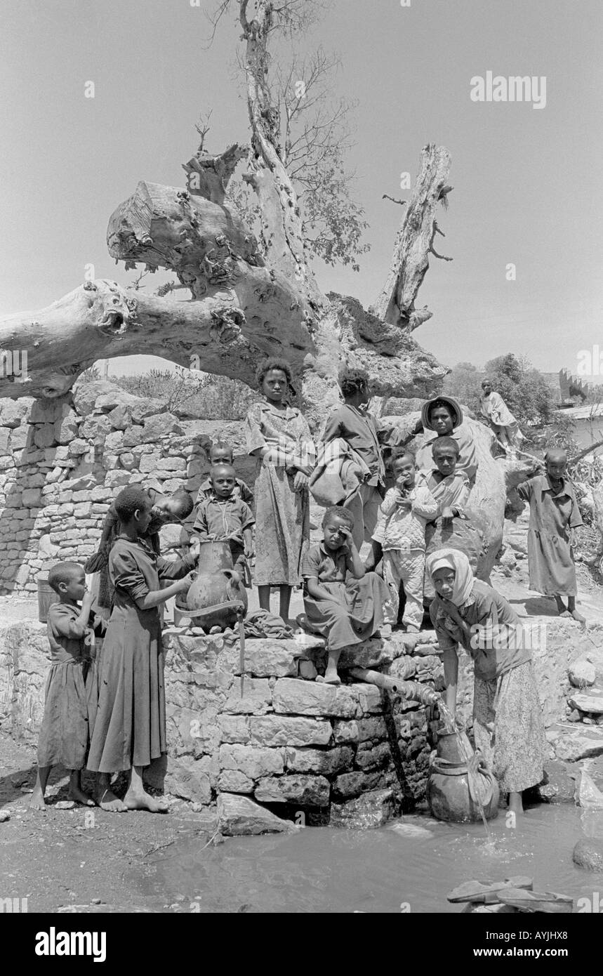 B/W of villagers drawing clean water from a capped spring in the ...