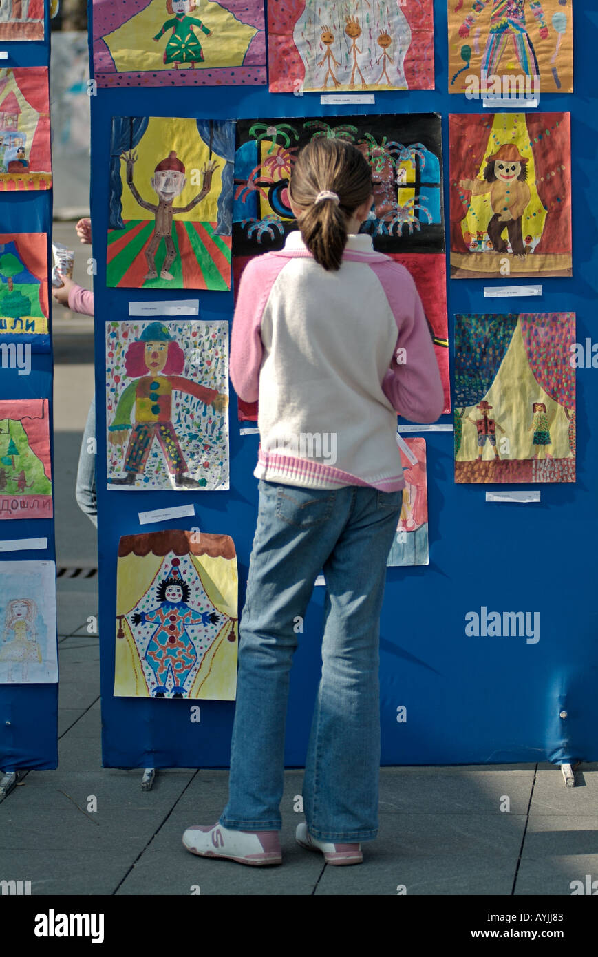 Young girl looking at a display of school art work Stock Photo - Alamy
