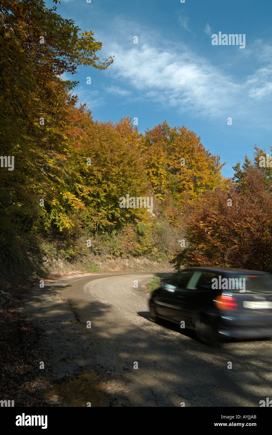 Car Driving Around a Bend of a Country Lane Stock Photo - Alamy