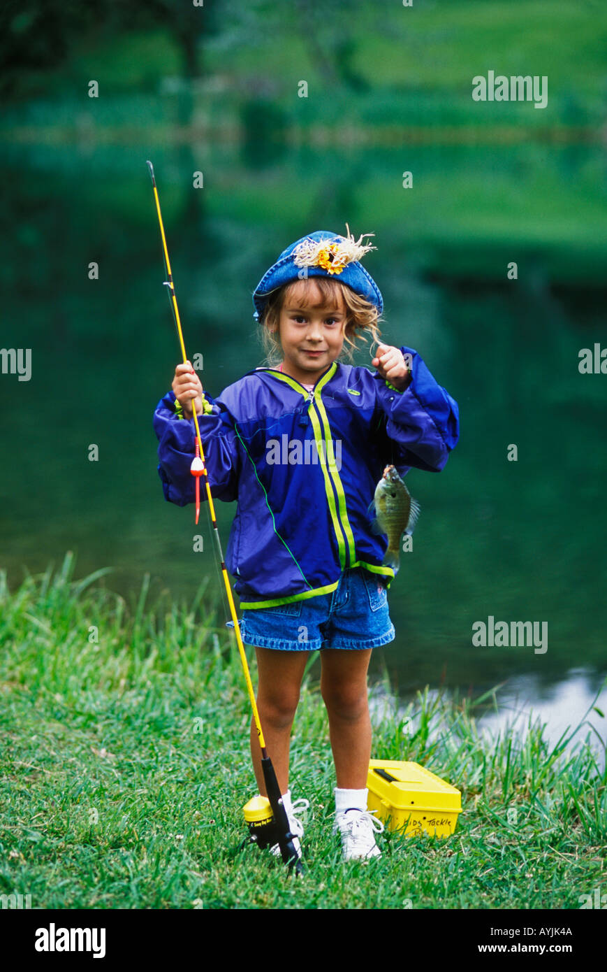 Young Girl With Fishing Rod Showing Off Caught Fish Stock Photo - Alamy