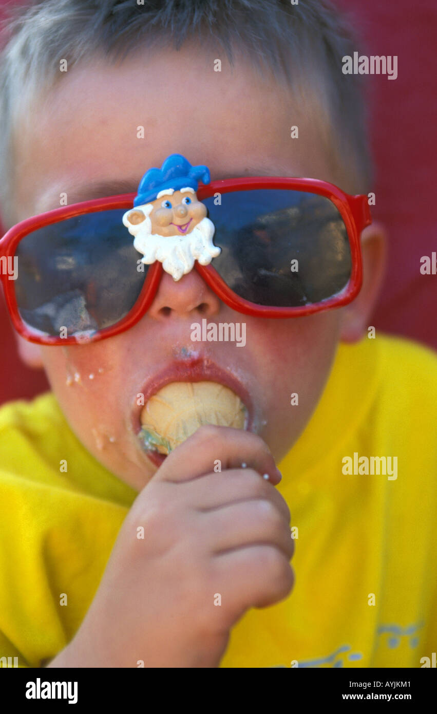 a young boy eating an icescream Stock Photo - Alamy