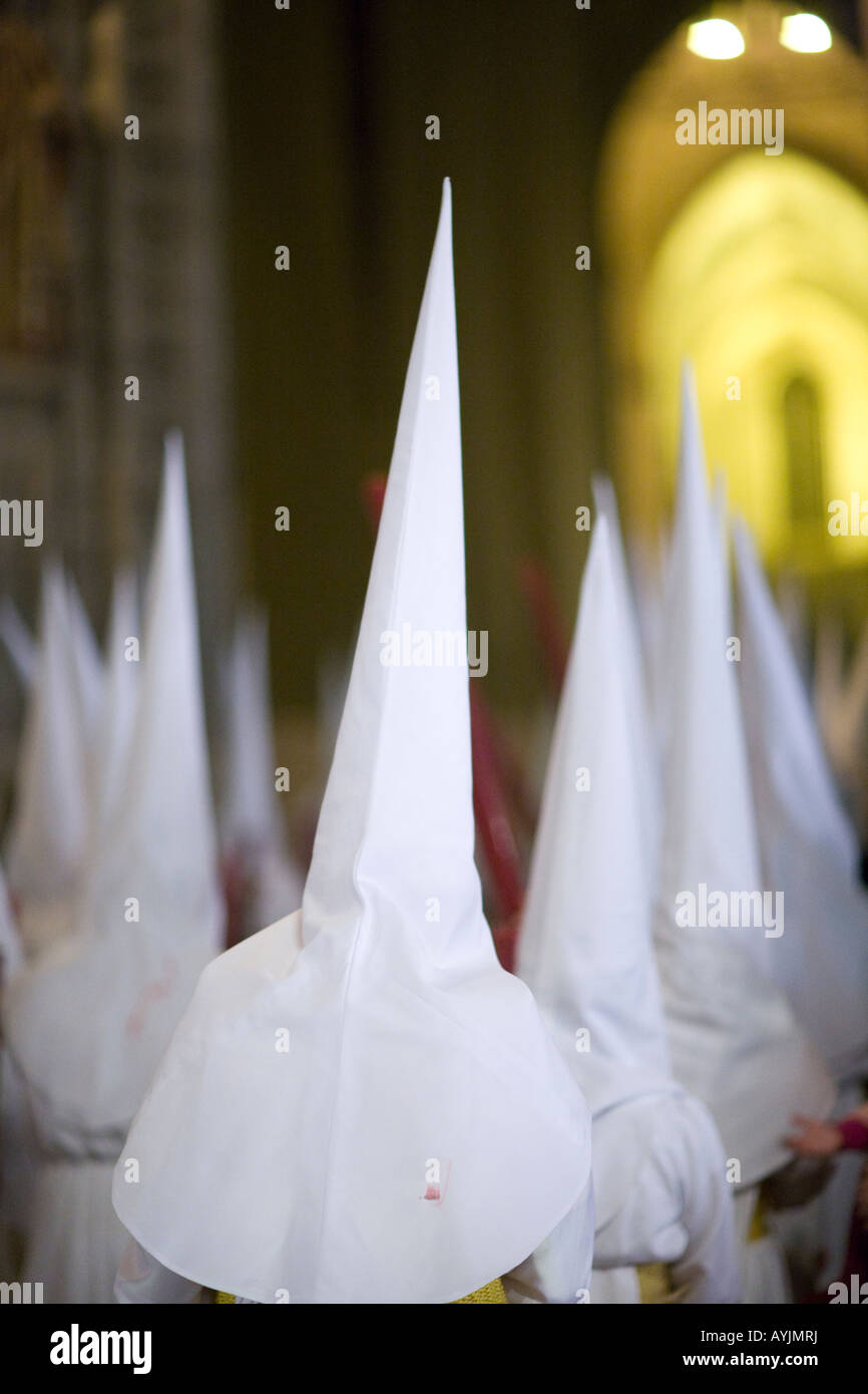Row of hooded penitents entering Seville's Cathedral, Spain Stock Photo ...