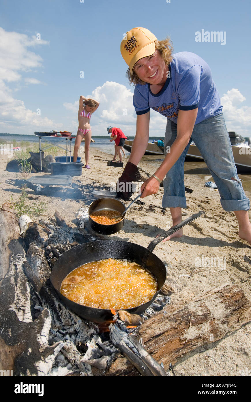 Guide cooking shore lunch Stock Photo - Alamy