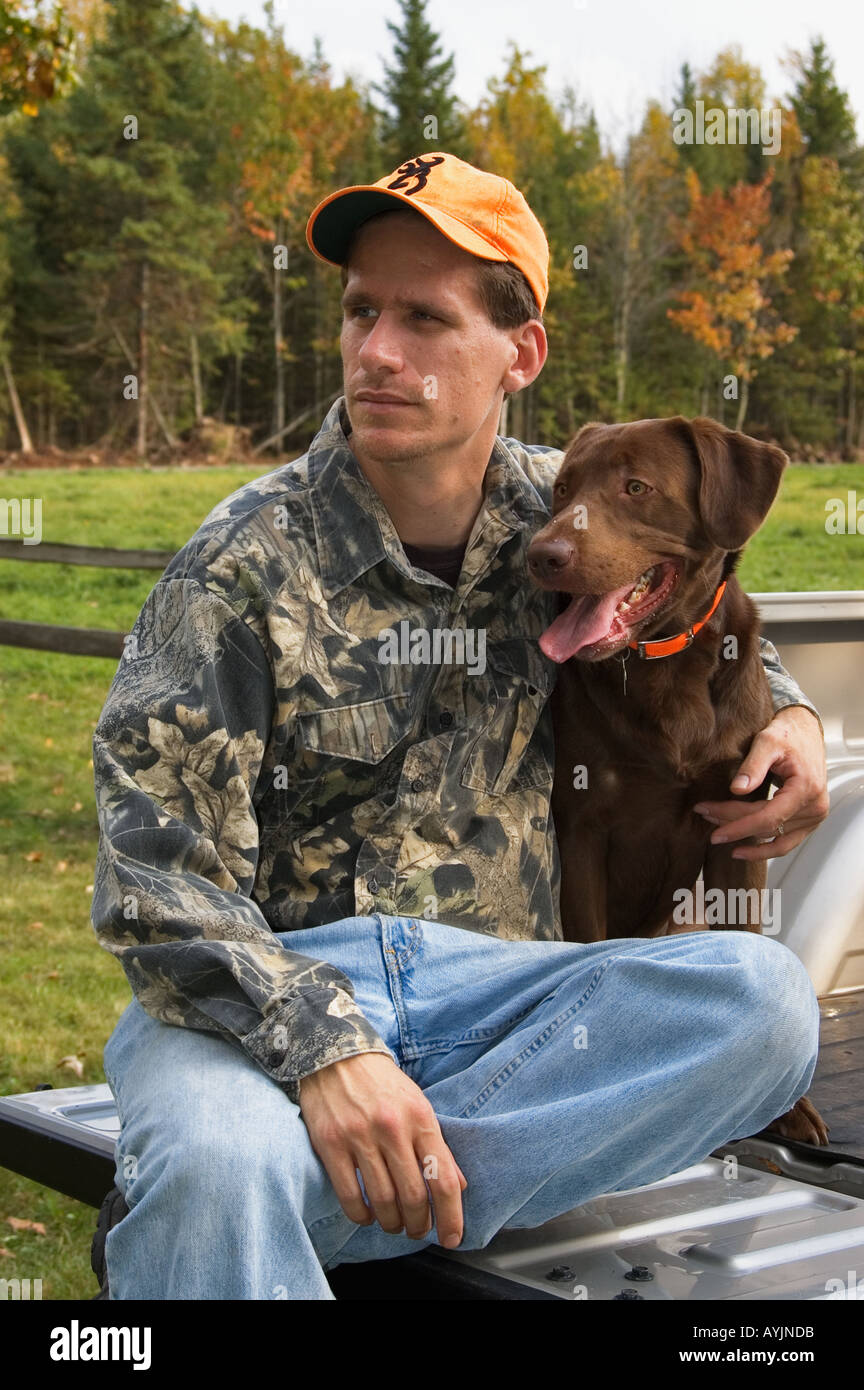 Bird Hunter Sitting on Truck Tailgate with his Chocolate Labrador ...