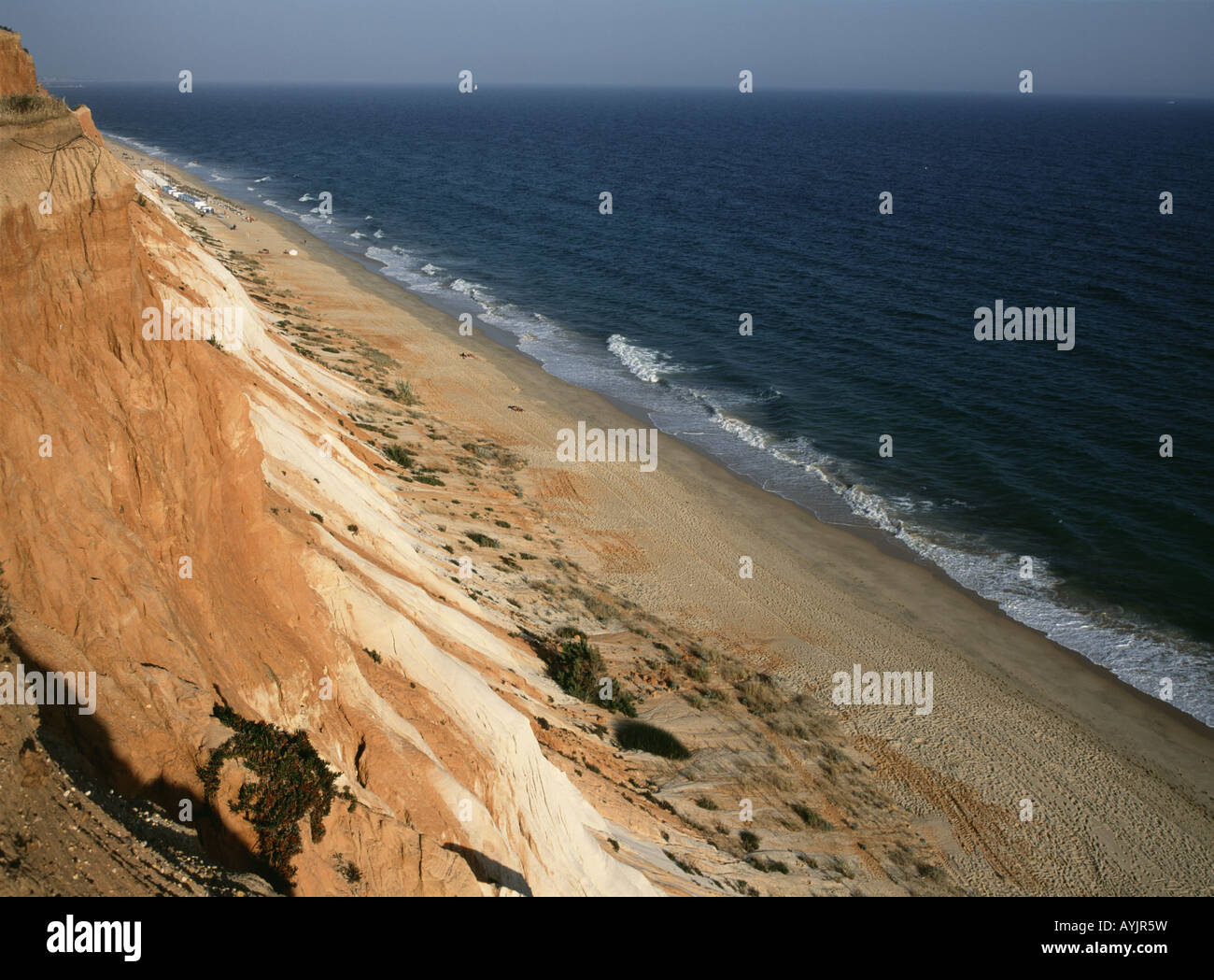 Falesia beach Long stretch of sand Cliffs Orange streaked mineral ...