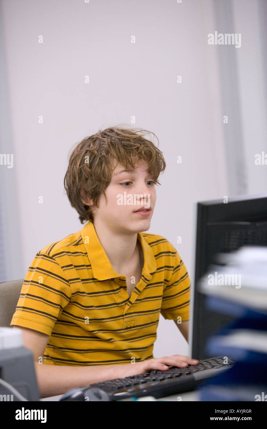 Teenage boy behind a computer Stock Photo - Alamy