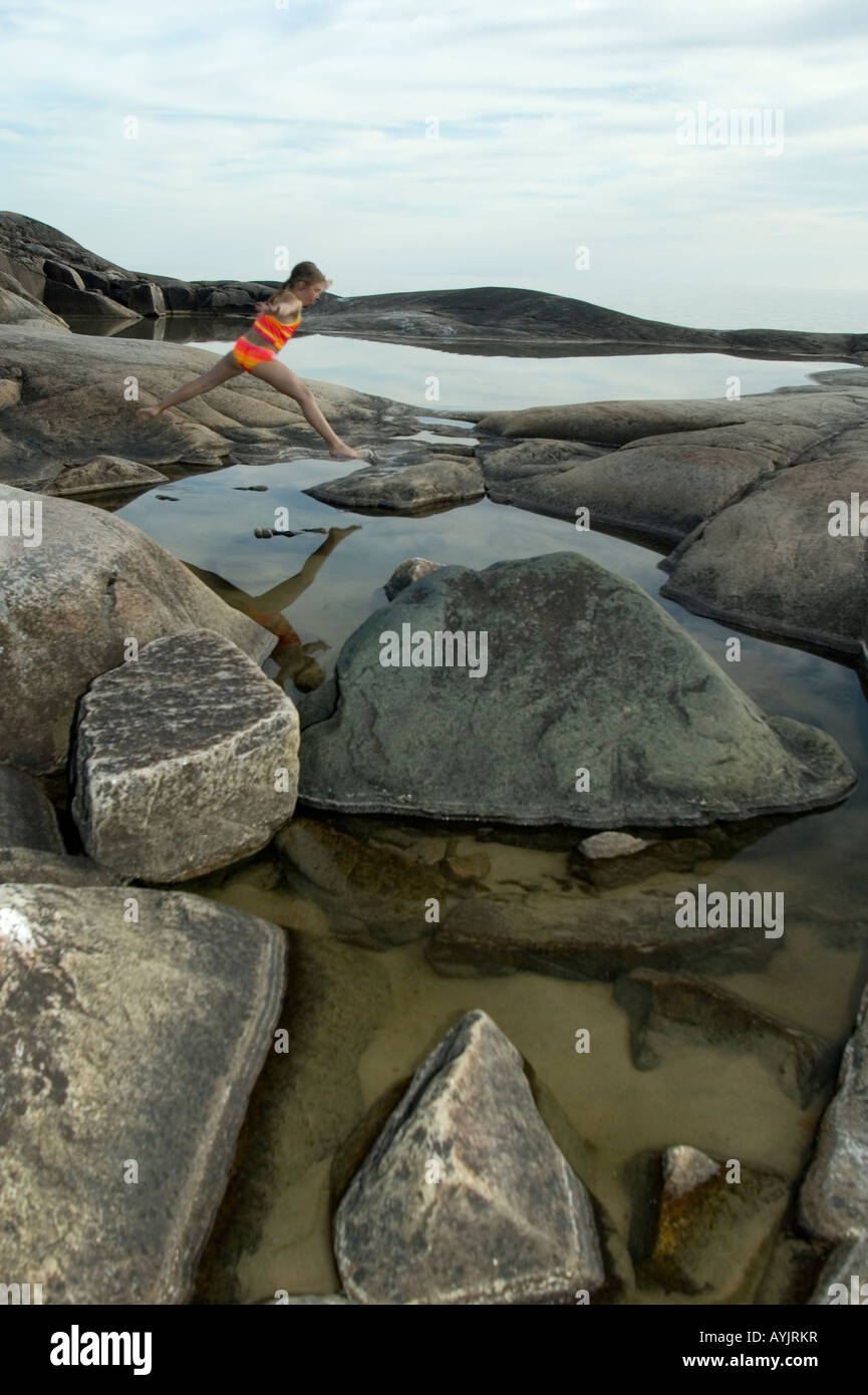 Girl walking over rocks hi-res stock photography and images - Alamy