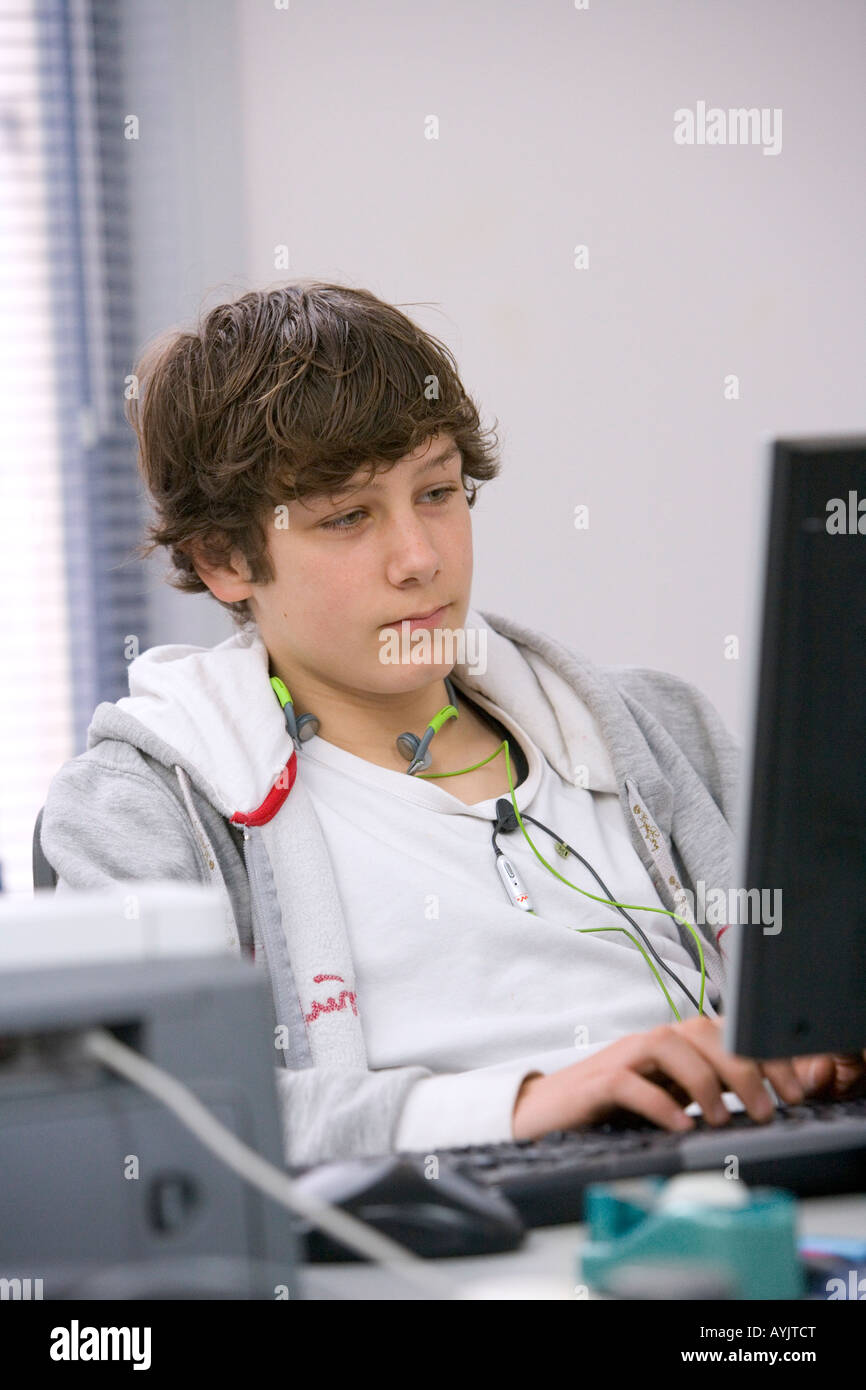 Teenage boy behind a computer Stock Photo - Alamy