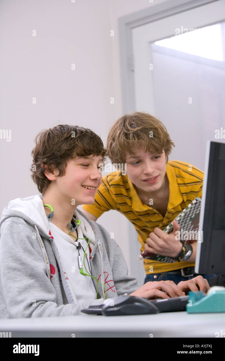 Two teenage boys behind a computer Stock Photo - Alamy
