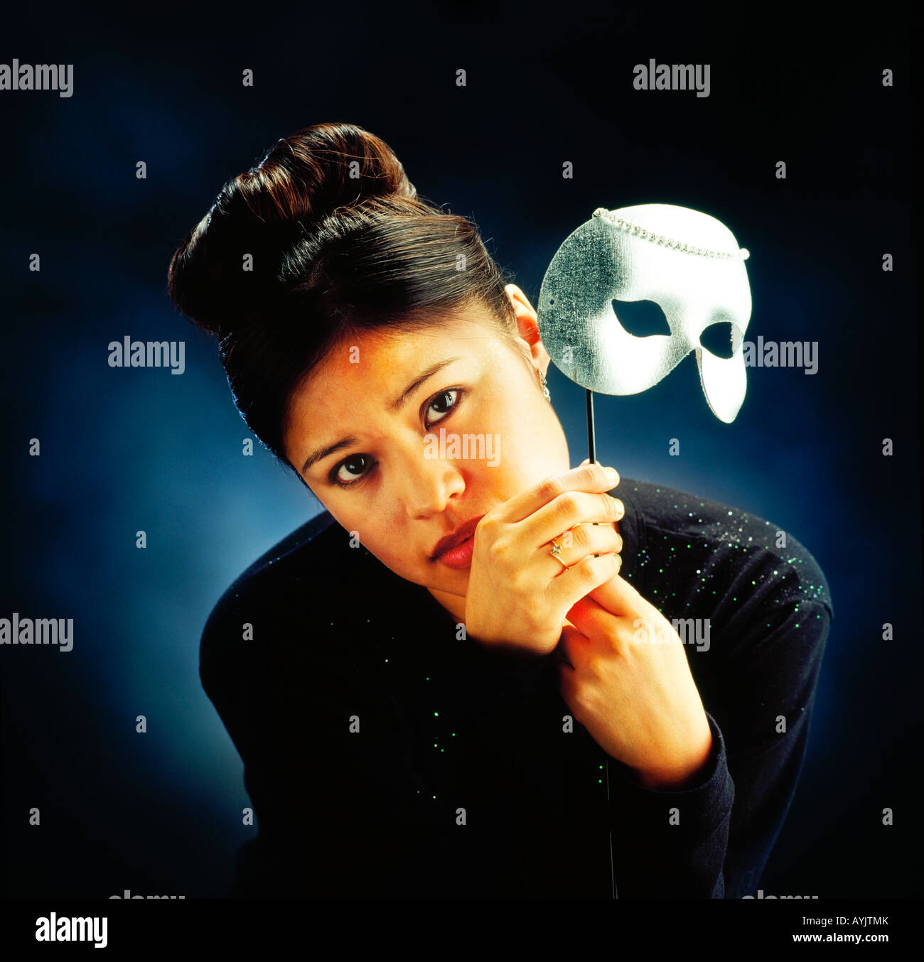 Woman holding mask Stock Photo - Alamy