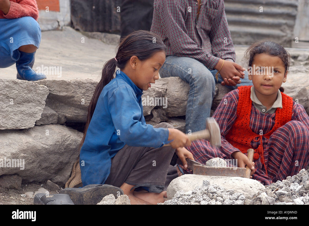 young children of about 8 years old at work at a stone quarry breaking ...