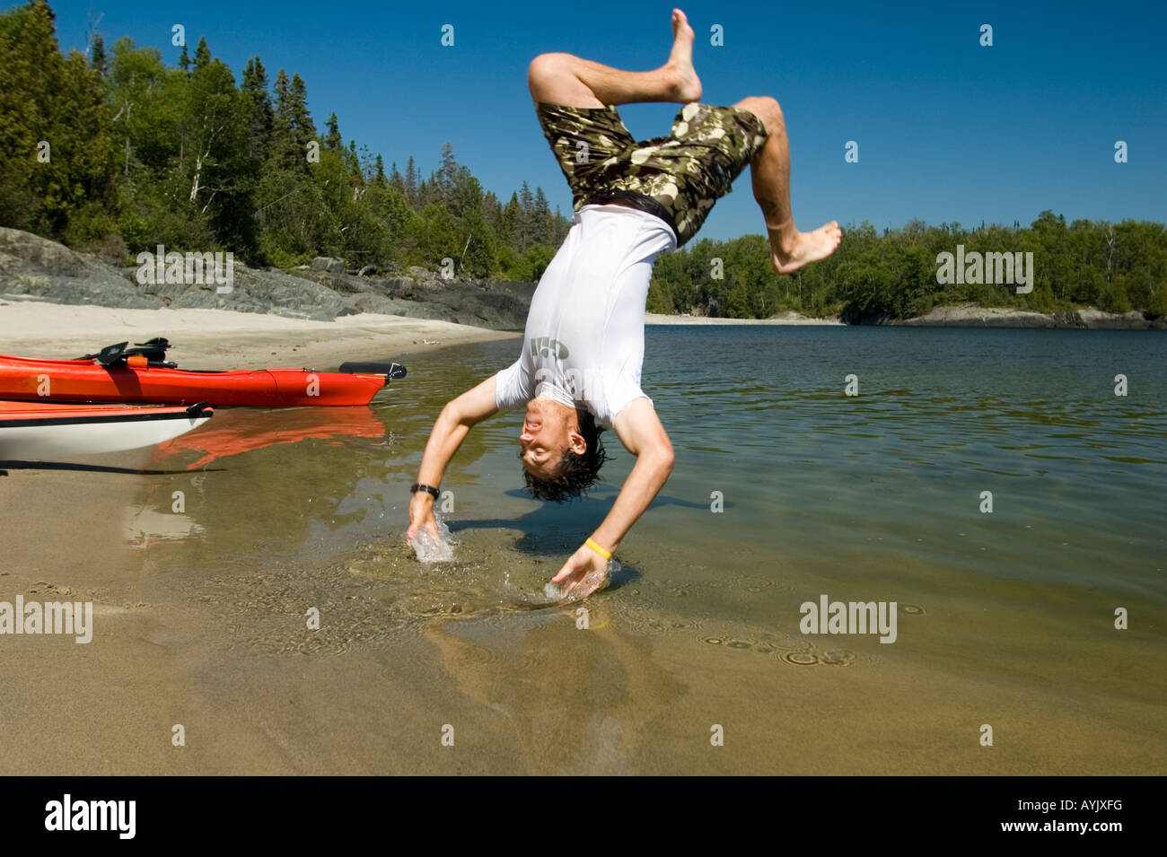 Kayaker doing back flip on beach Stock Photo - Alamy